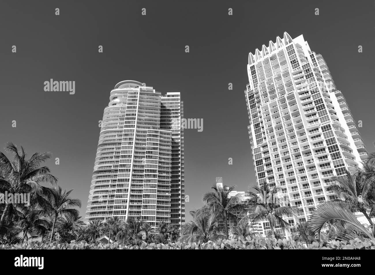 Modern skyscrapers high-rise buildings architecture and palms on blue ...