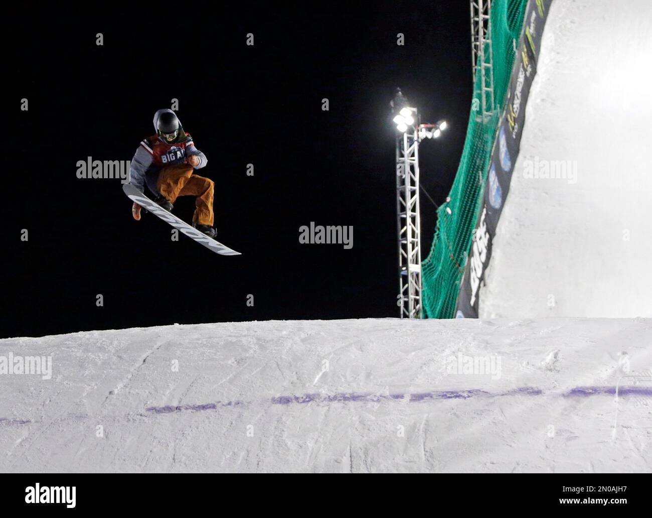 Snowboarder Michael Ciccarelli, of Canada, jumps during the Big Air at Fenway skiing and ...