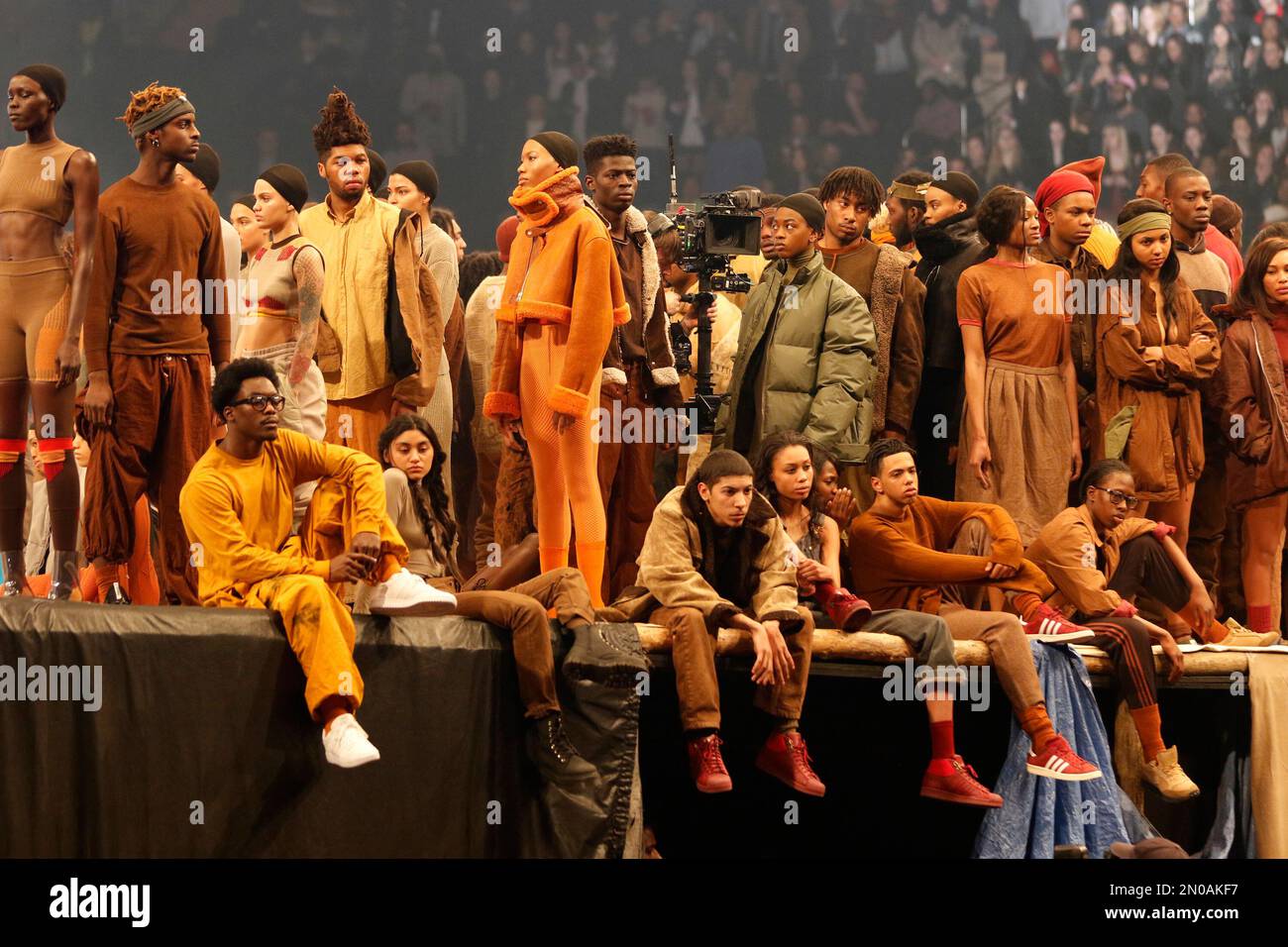 Models wear fashion from the Yeezy collection at a presentation and ...