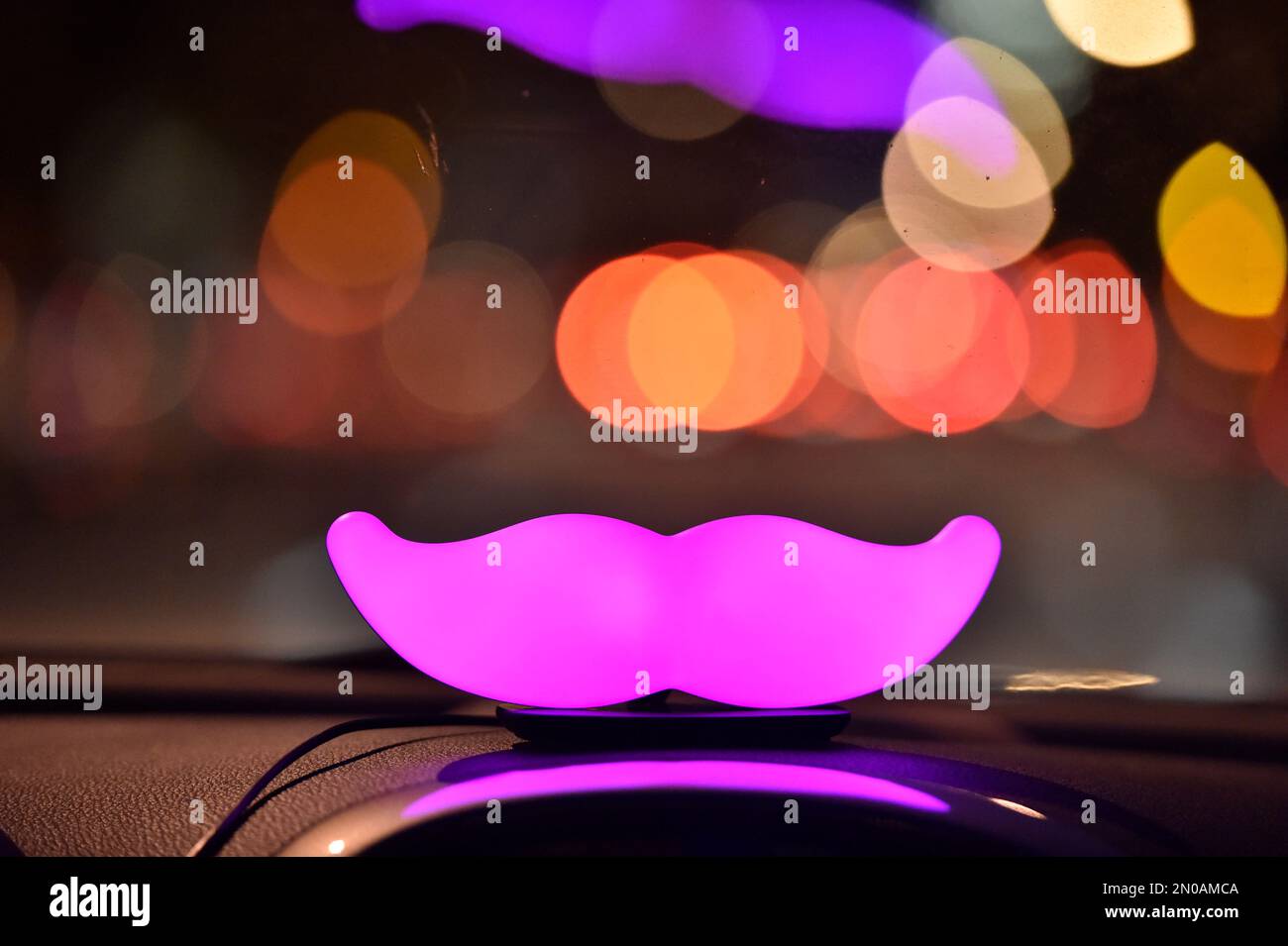 A Lyft Glowstache glows on the dashboard of a car in San Francisco on ...