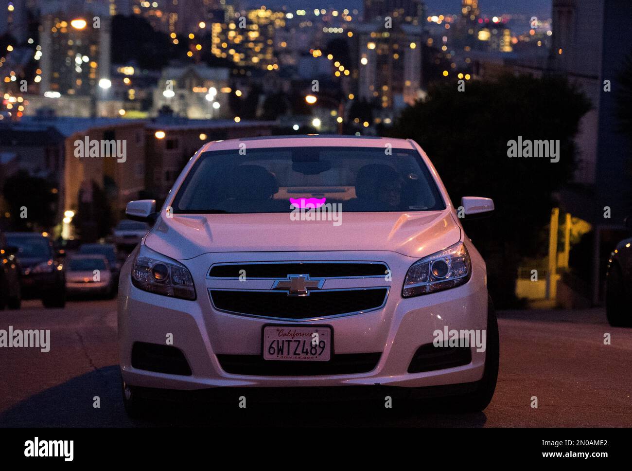 A Lyft Glowstache glows on the dashboard of a car in San Francisco on ...
