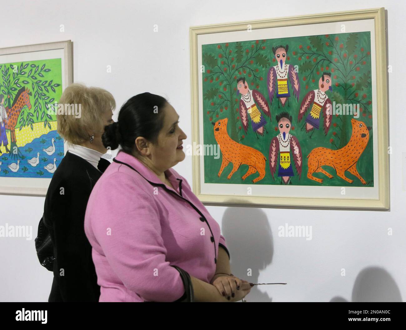 Visitors look at painting by Maria Primachenko, a renowned Ukrainian ...