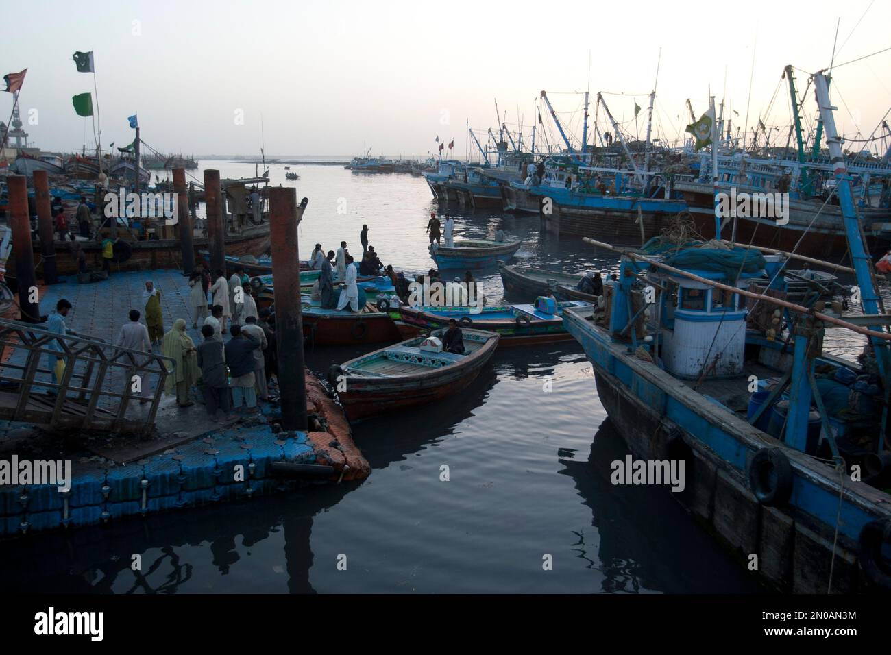 Pakistani fishermen get ready to sail for fishing at Karachi harbor in ...