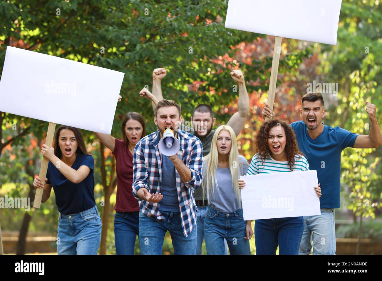 Emotional young man with megaphone at protest outdoors Stock Photo - Alamy