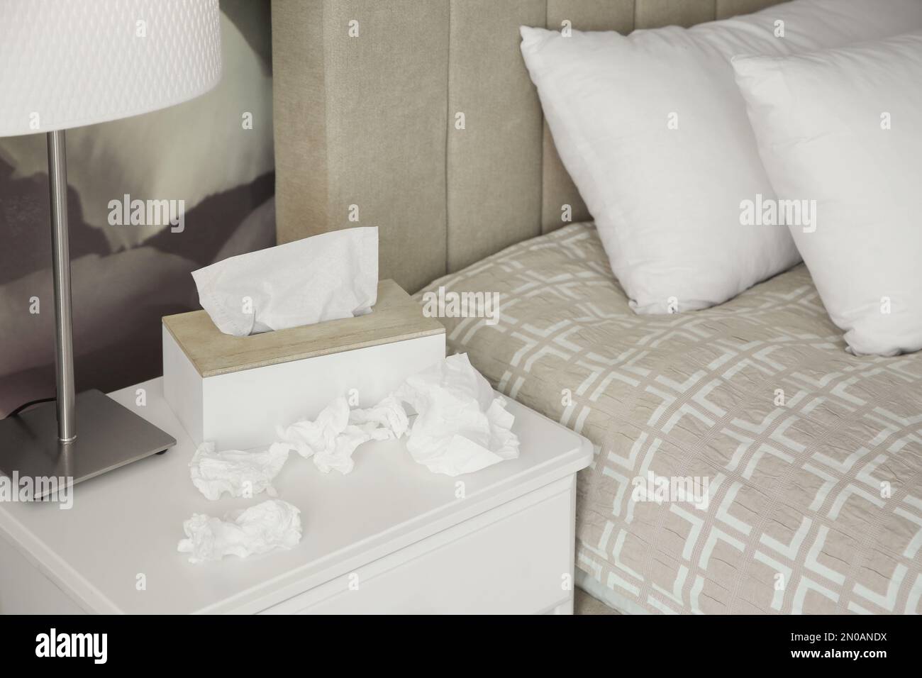 Used paper tissues and holder on table in bedroom Stock Photo - Alamy