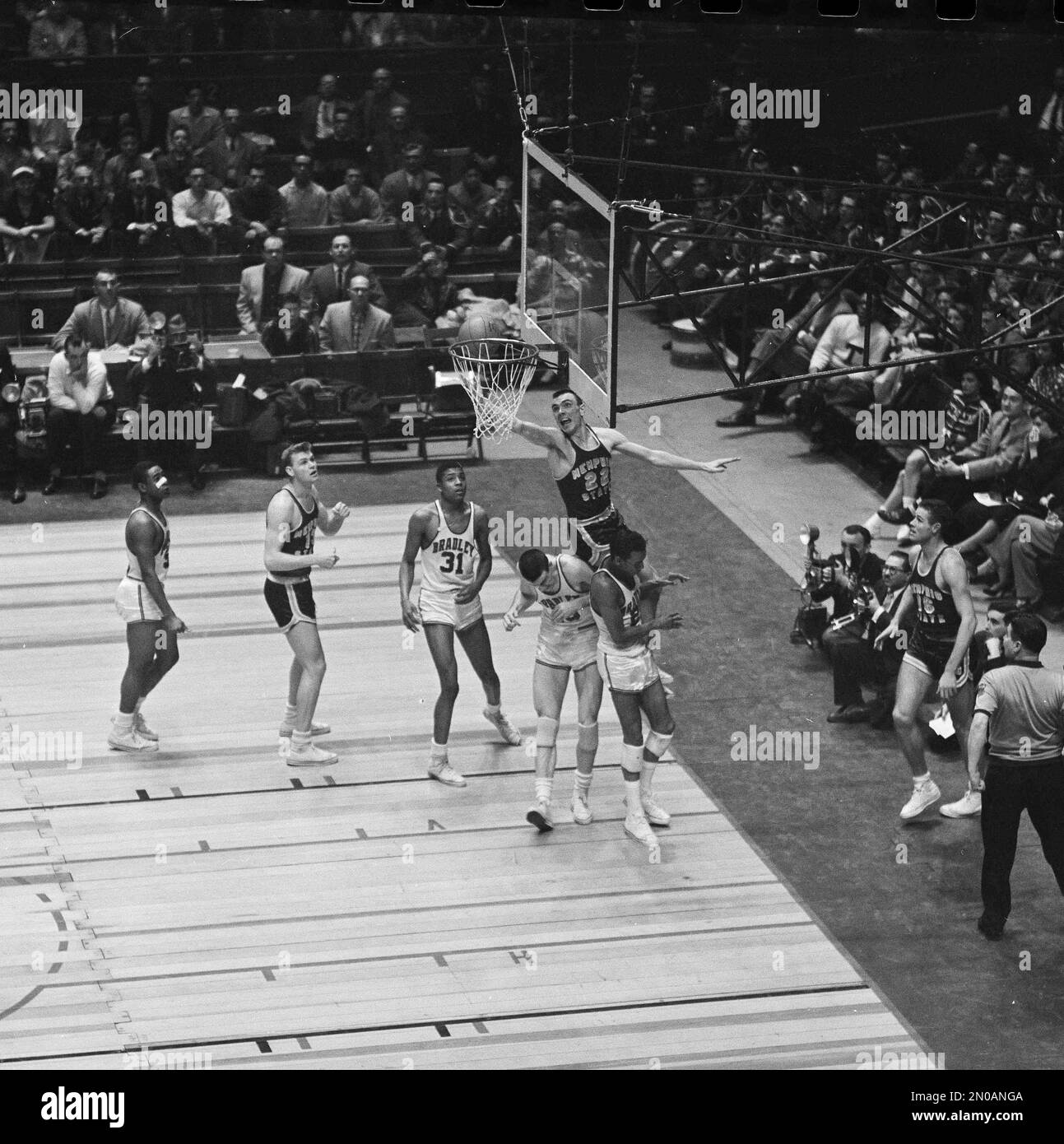 Win Wilfong (22) of Memphis State reaches around Bradley University ...