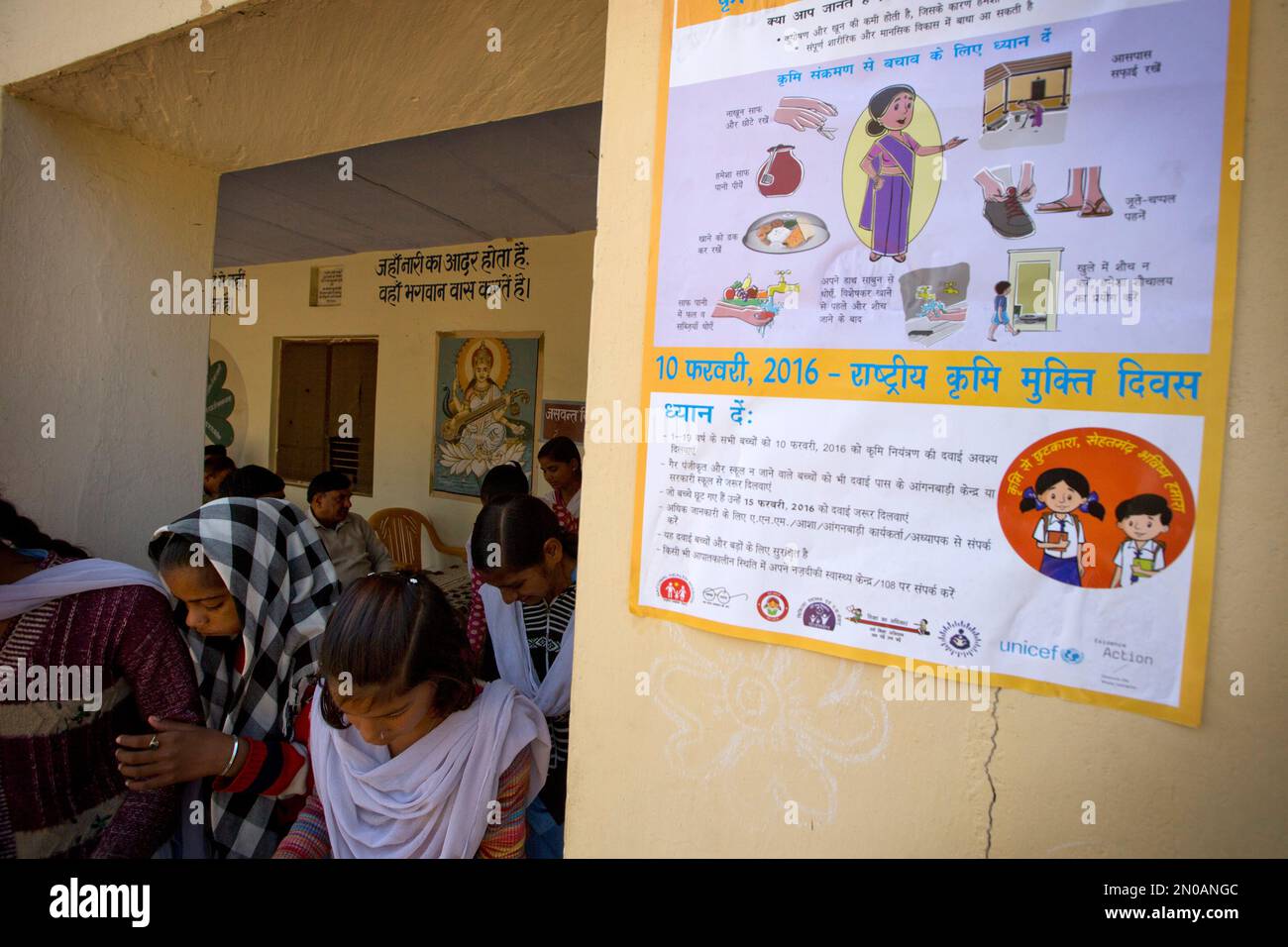 Posters about worms in the body are posted on the wall during deworming ...