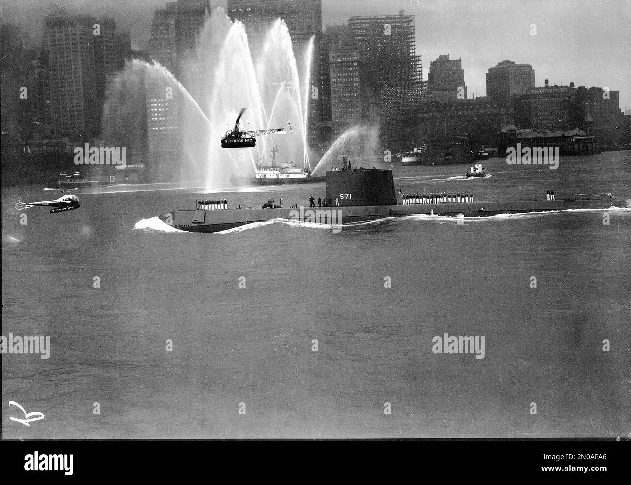 A New York City police helicopter hovers low over the atomic submarine ...