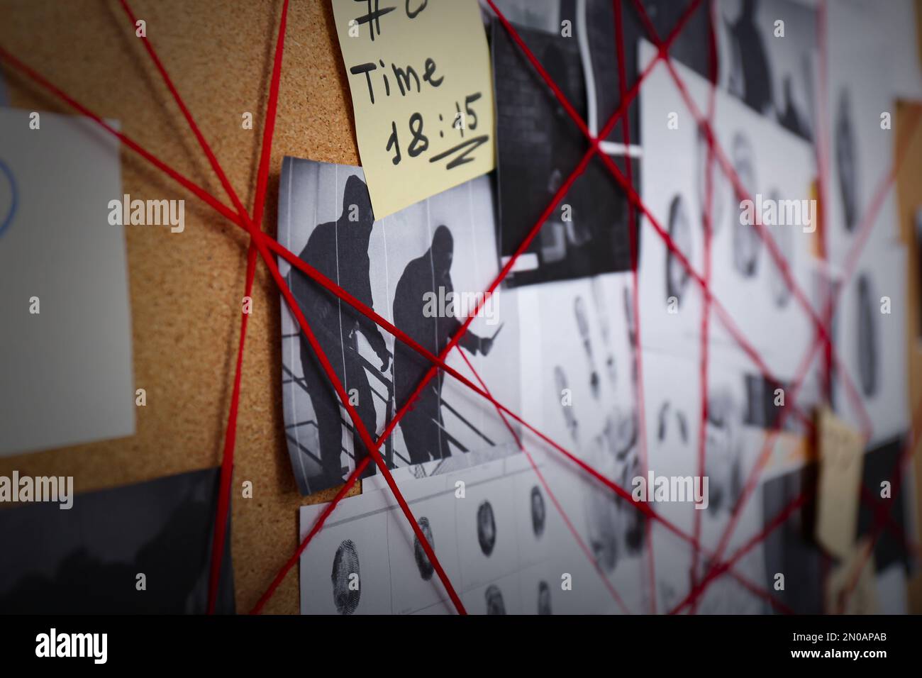 Detective board with crime scene photos, fingerprints and red threads ...