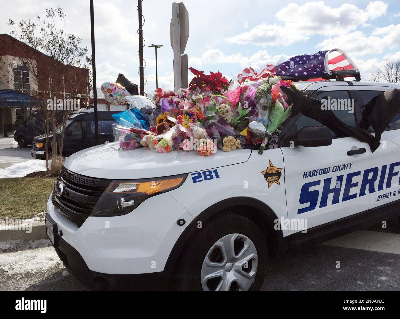 Tributes in memory of two slain deputies are stacked on a Harford ...