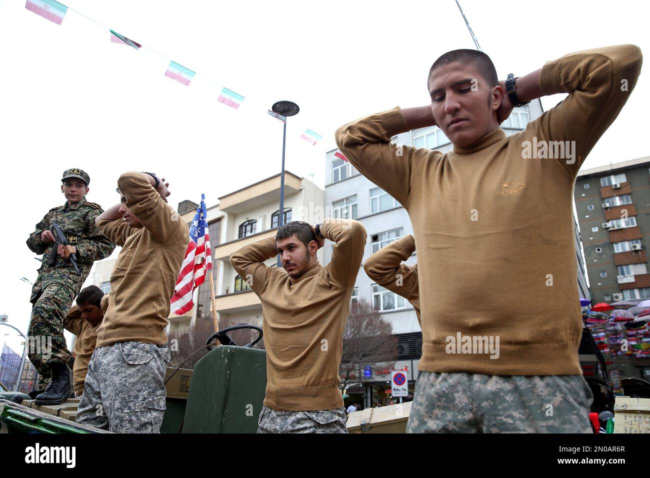 Members of Iranian Basij paramilitary force re-enact the January ...