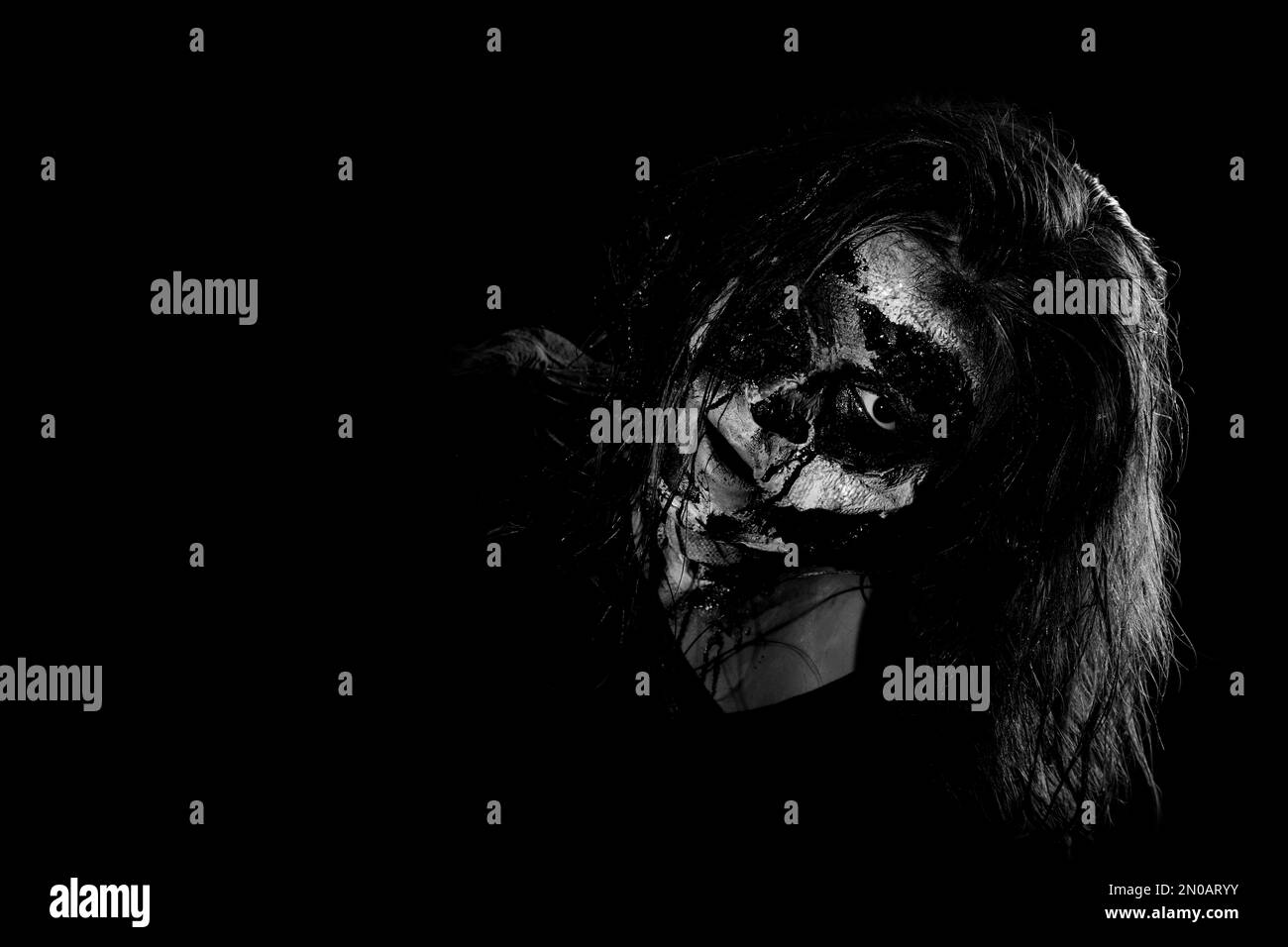 Scary zombie on dark background, black and white effect with space for ...
