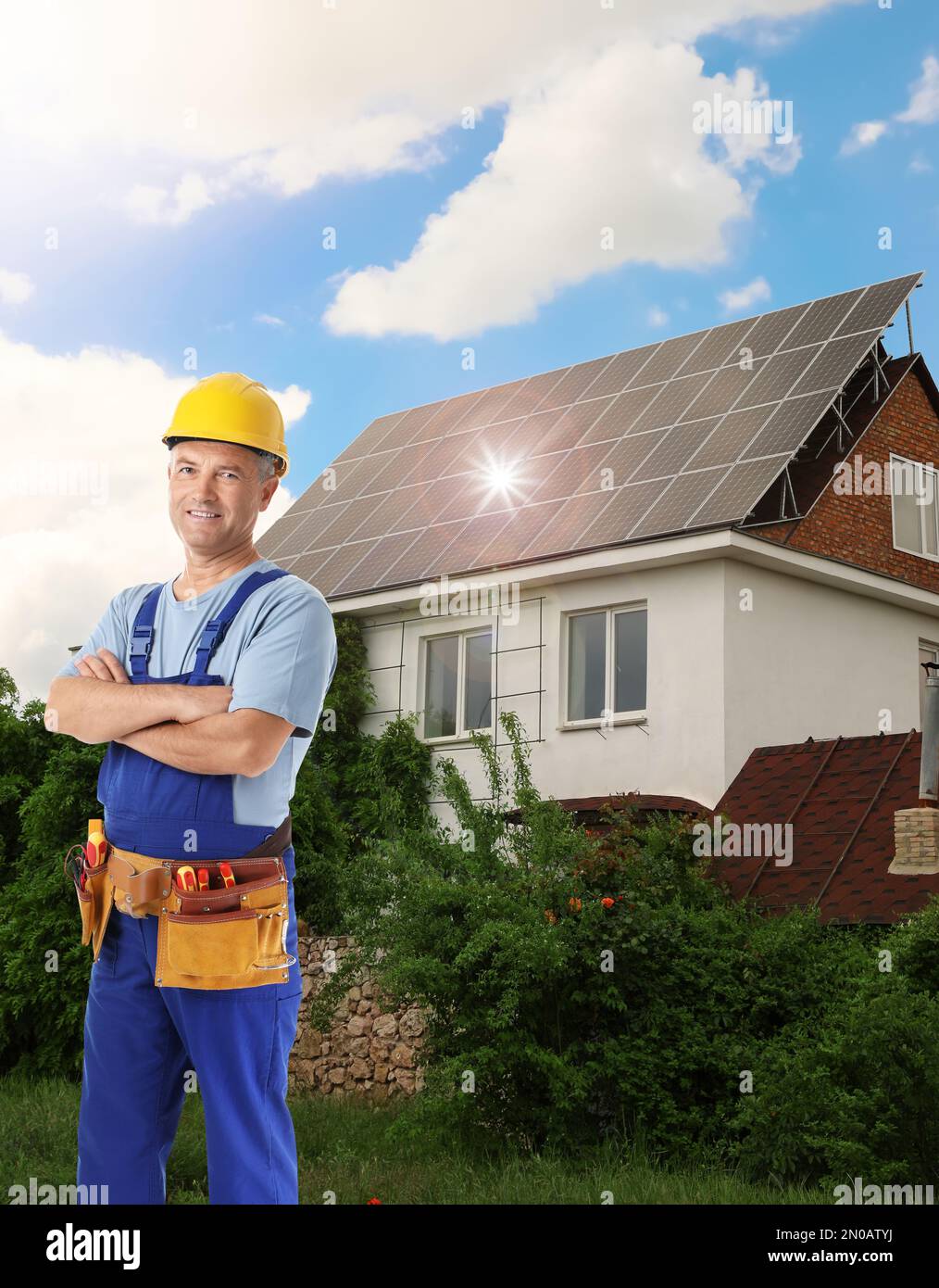 Engineer near house with installed solar panels. Alternative energy ...