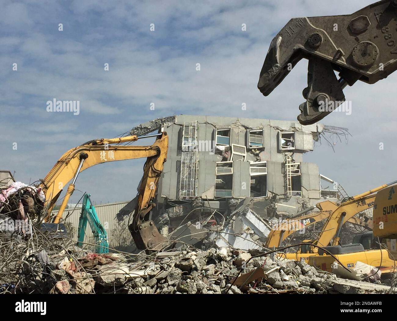 Rescue teams continue to use heavy excavation machinery to dig through ...