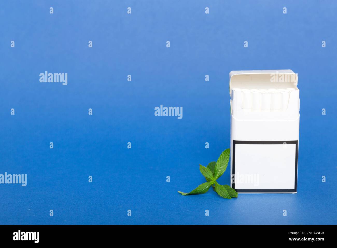 Pack of menthol cigarettes and fresh mint on colored table, Menthol ...