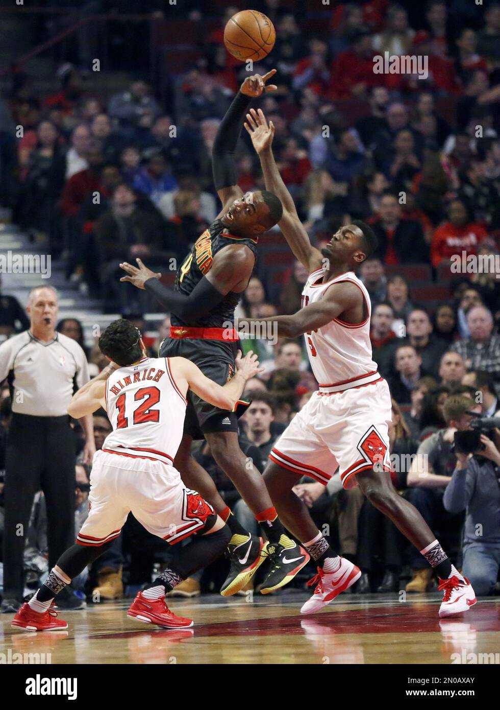 Atlanta Hawks forward Paul Millsap, center, jumps over the pressure by ...