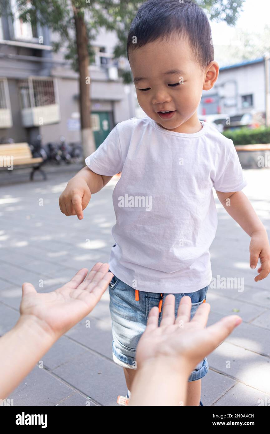 A little boy is learning to walk Stock Photo - Alamy