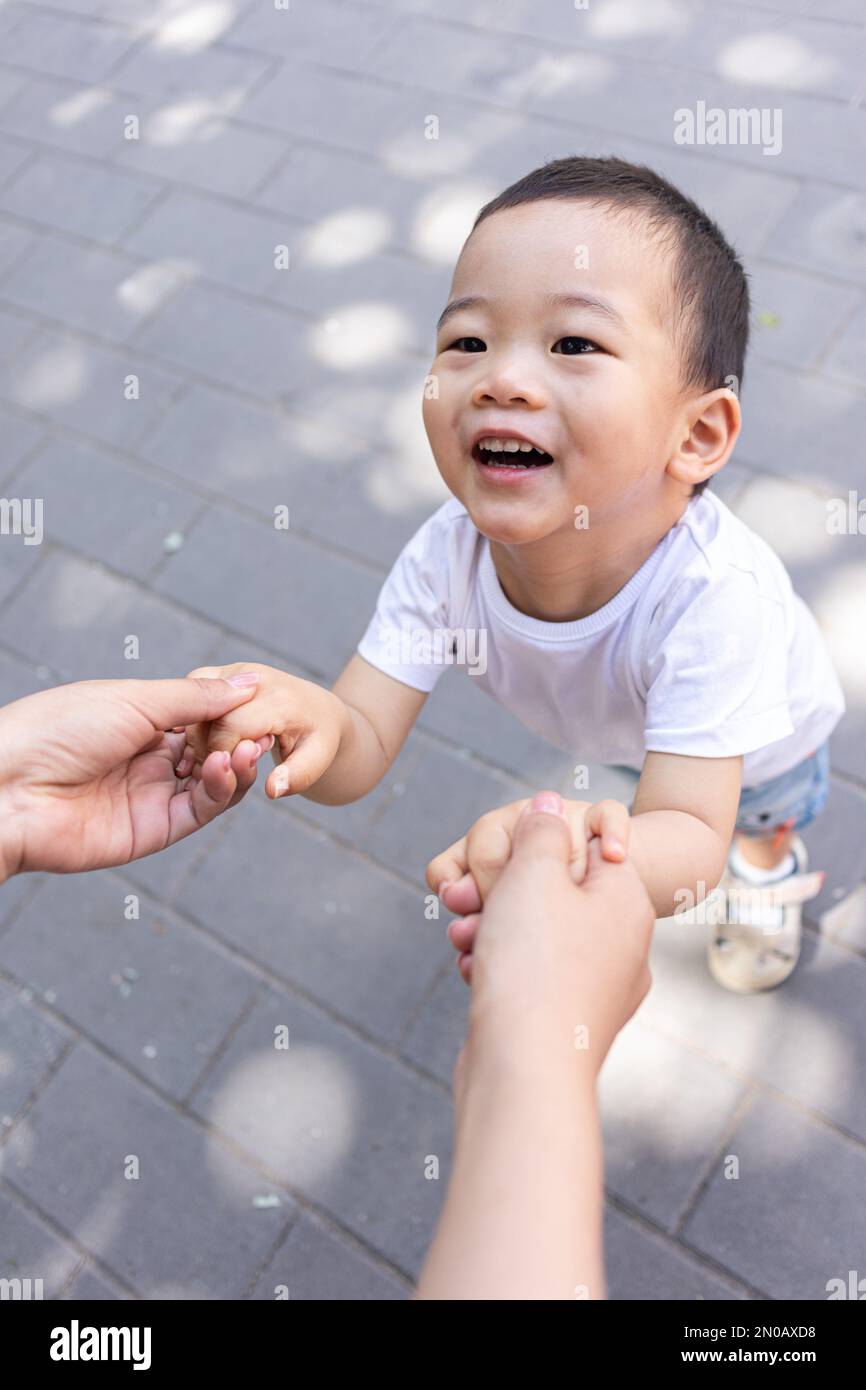 A little boy is learning to walk Stock Photo - Alamy