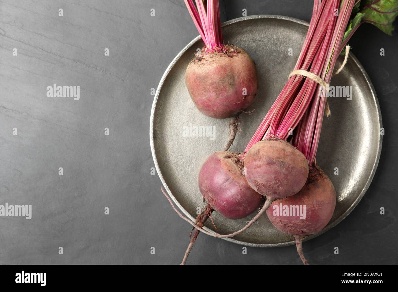 Raw ripe beets on black slate table, top view. Space for text Stock ...