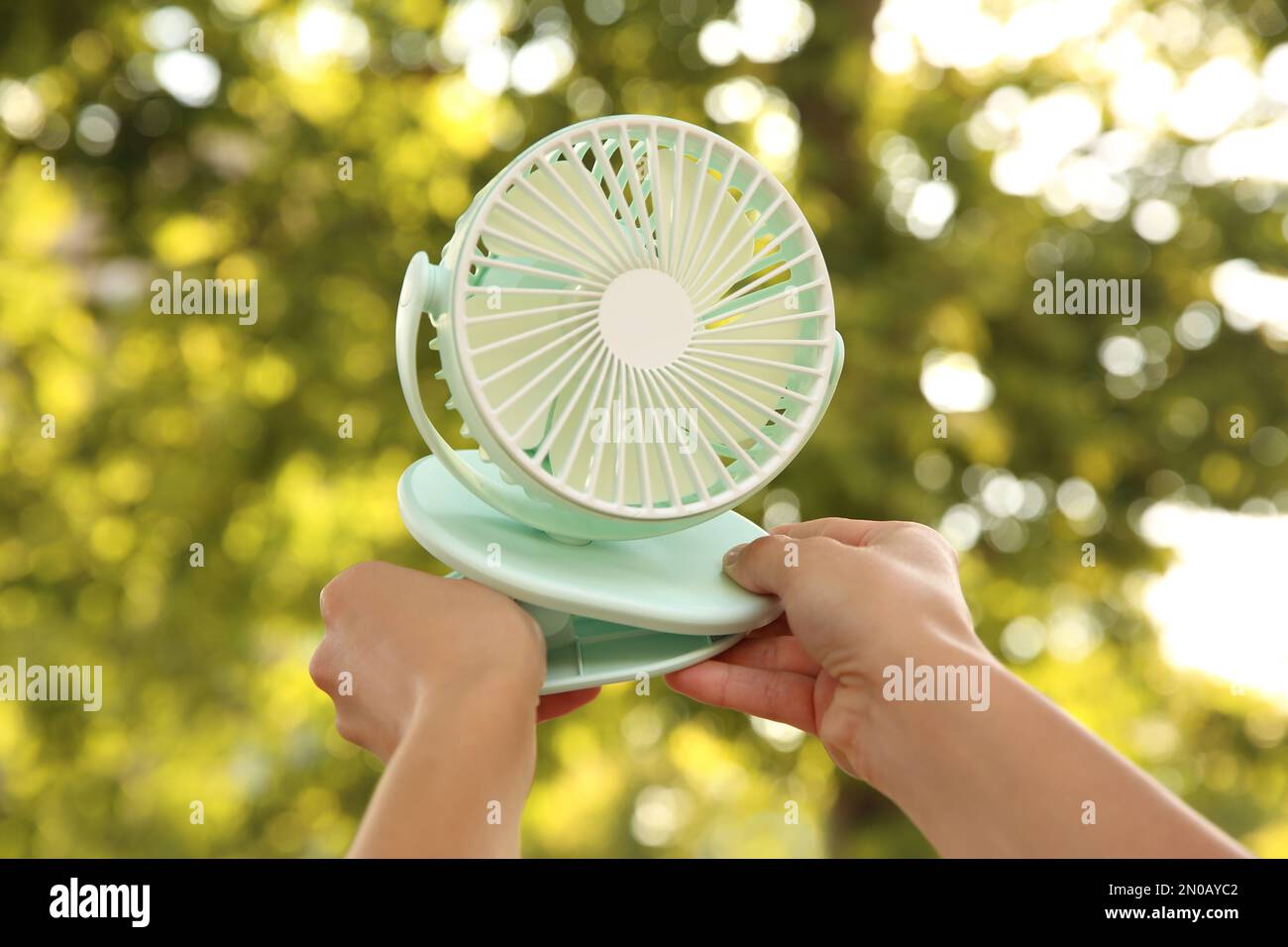 Woman holding mini fan hi-res stock photography and images - Alamy