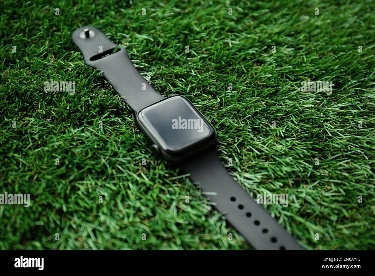 Modern stylish smart watch on green grass, closeup Stock Photo - Alamy