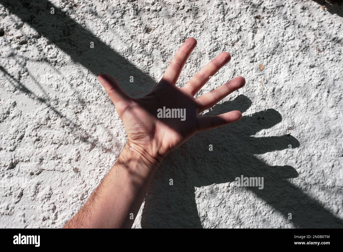 hand on the white wall gesturing with shadows Stock Photo - Alamy