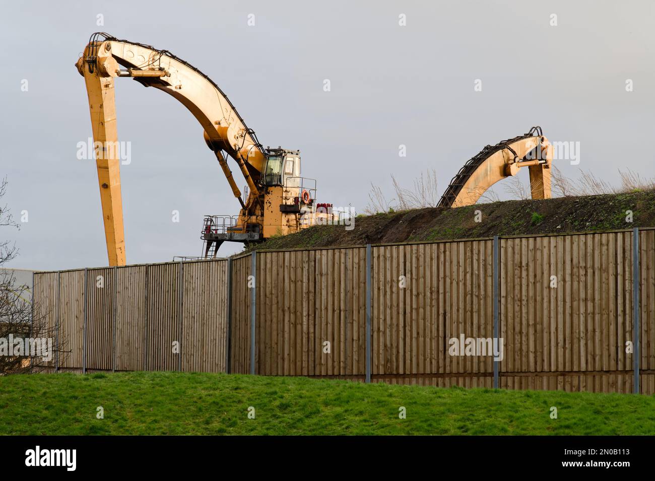 Construction site digger yellow during excavation on building site ...