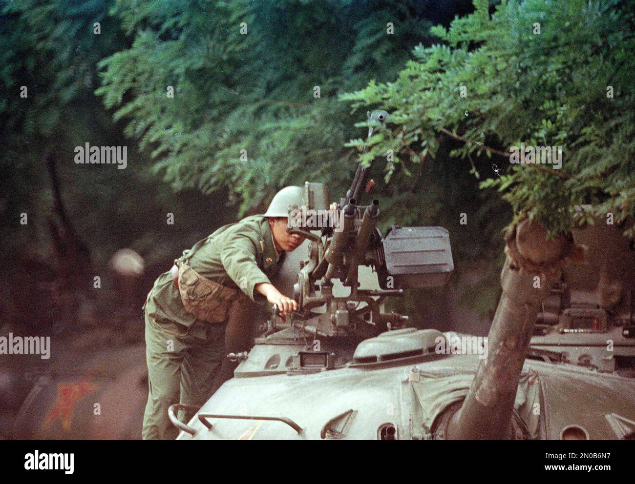A soldier checks the aim of his tank parked near the Beijing hotel, a ...