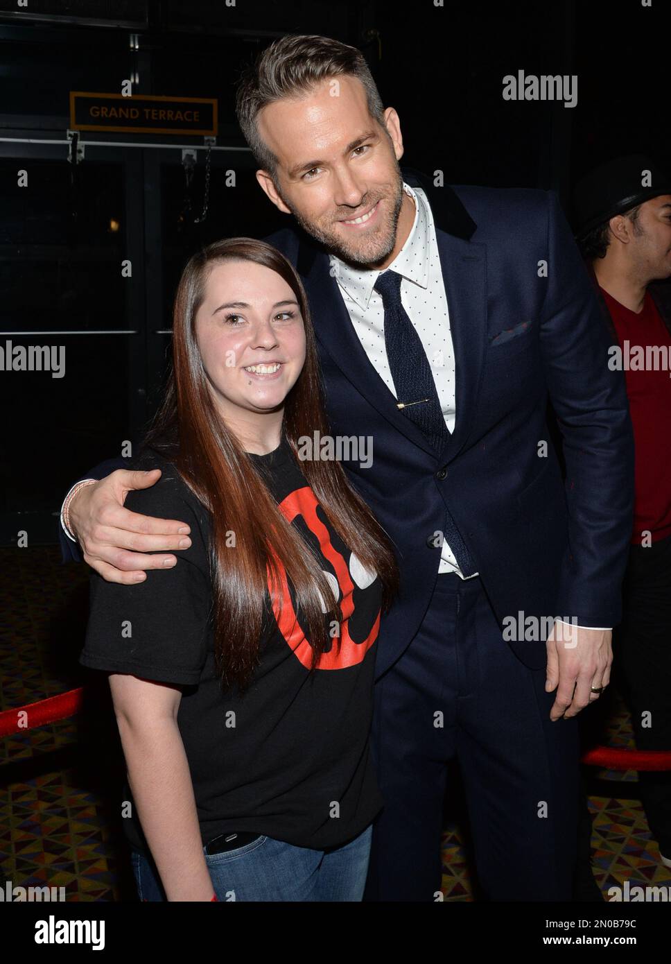 Actor Ryan Reynolds poses with a fan at a special fan screening of ...