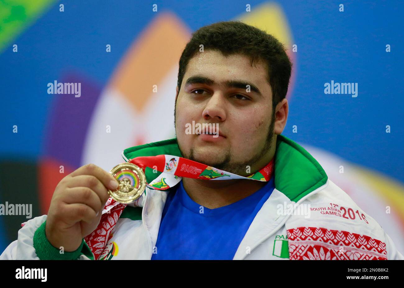 Pakistan's Mohammad Nooh Dastagir displays his gold medal for the Super ...