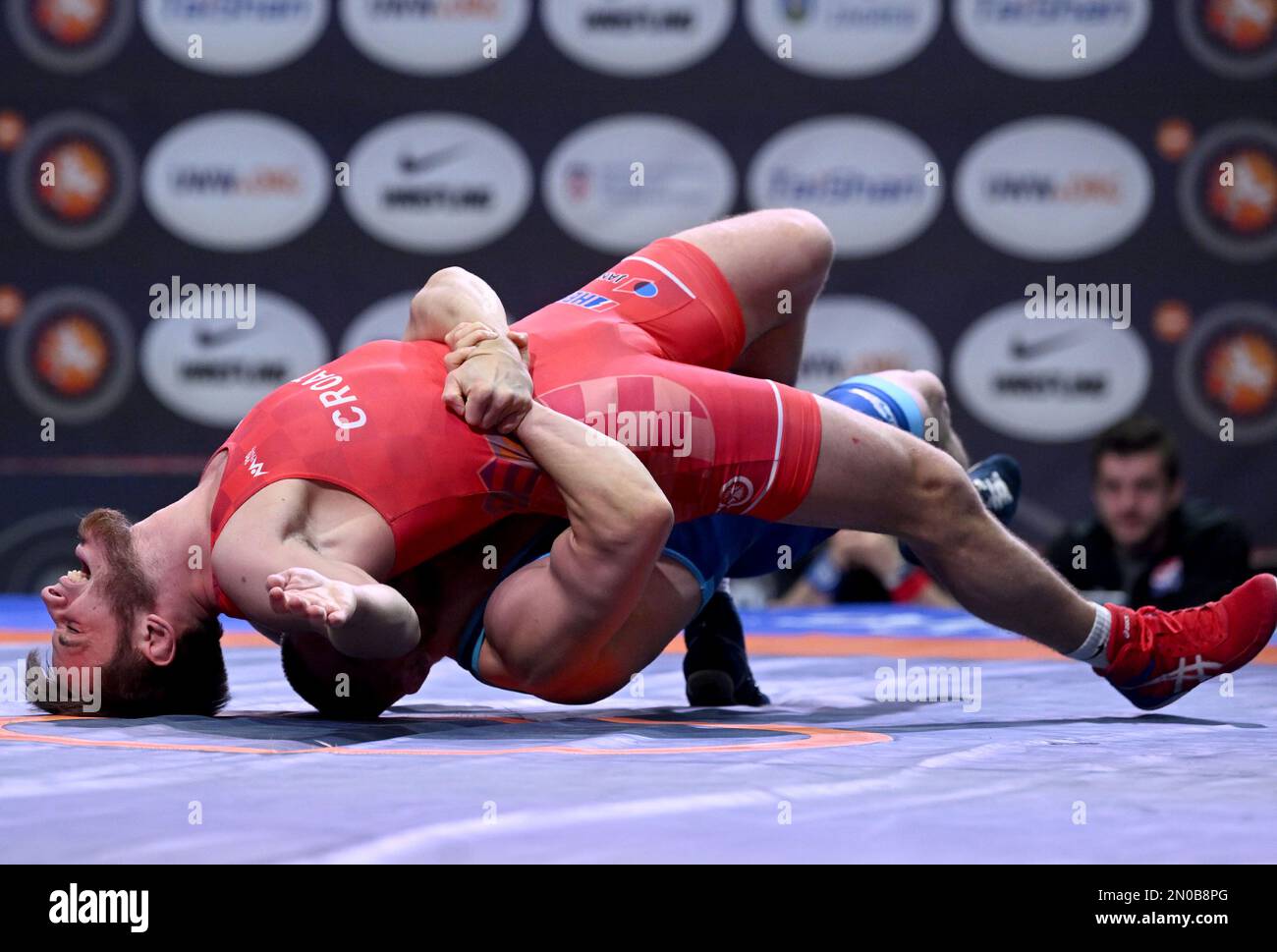 ZAGREB, CROATIA – FEBRUARY 05: Luka Malobabic of Croatia (red) competes ...