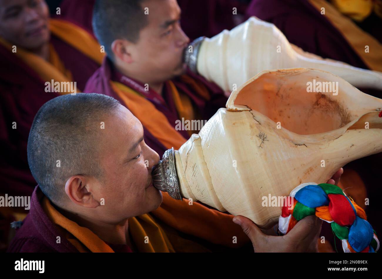 Exiled Tibetan Buddhist monks blow conch shells during a special prayer session on the first day ...