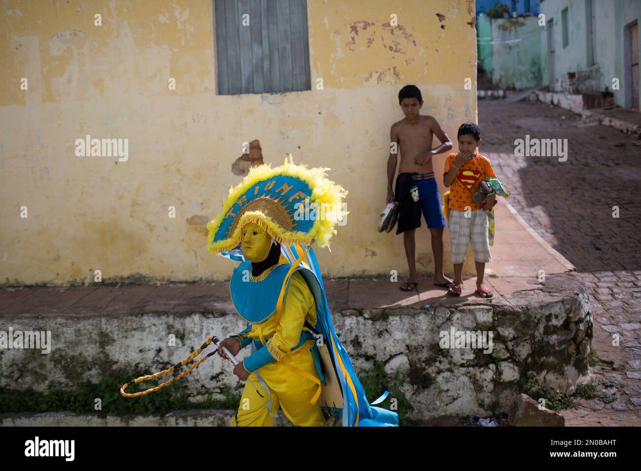 A young "Careta" makes his way to a parade during Carnival in Triunfo ...