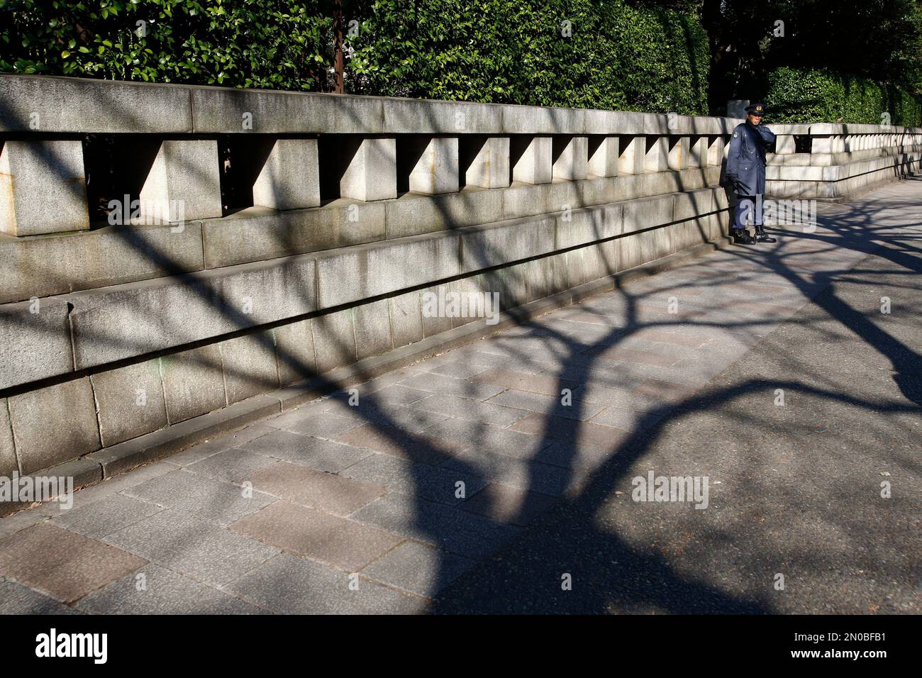 A Japanese police officer stands guard outside Yasukuni Shrine in Tokyo ...