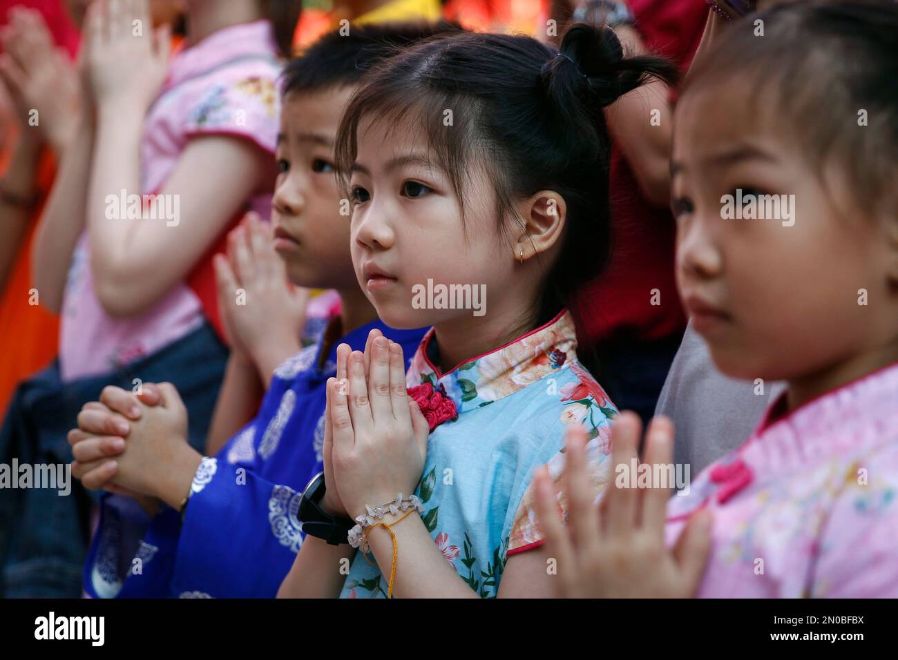 Malaysian ethnic Chinese children pray on the first day of Lunar New ...