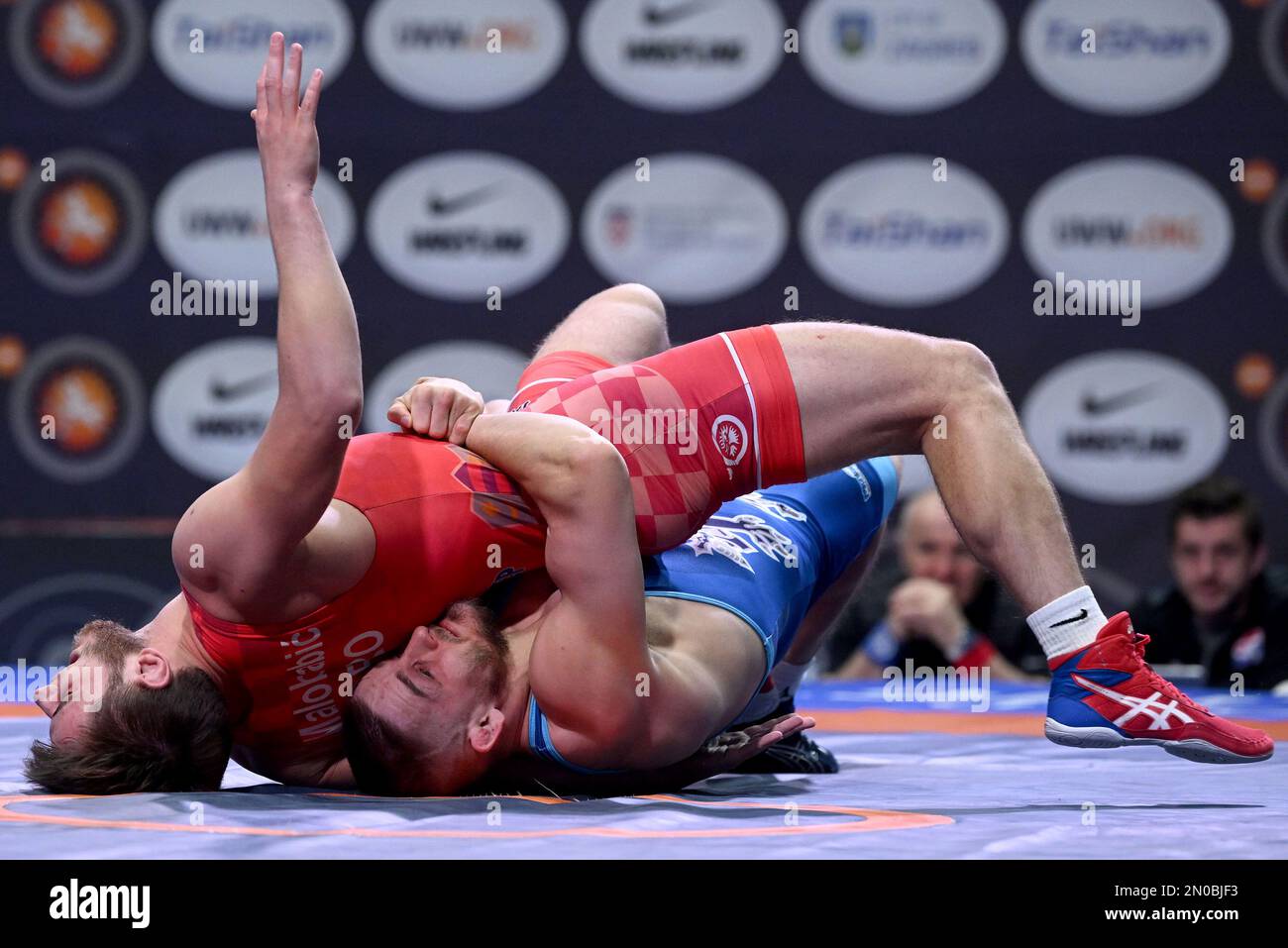 ZAGREB, CROATIA – FEBRUARY 05: Luka Malobabic of Croatia (red) competes ...
