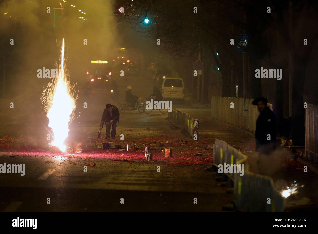 People light up fireworks on a road during the Eve of Chinese New Year ...