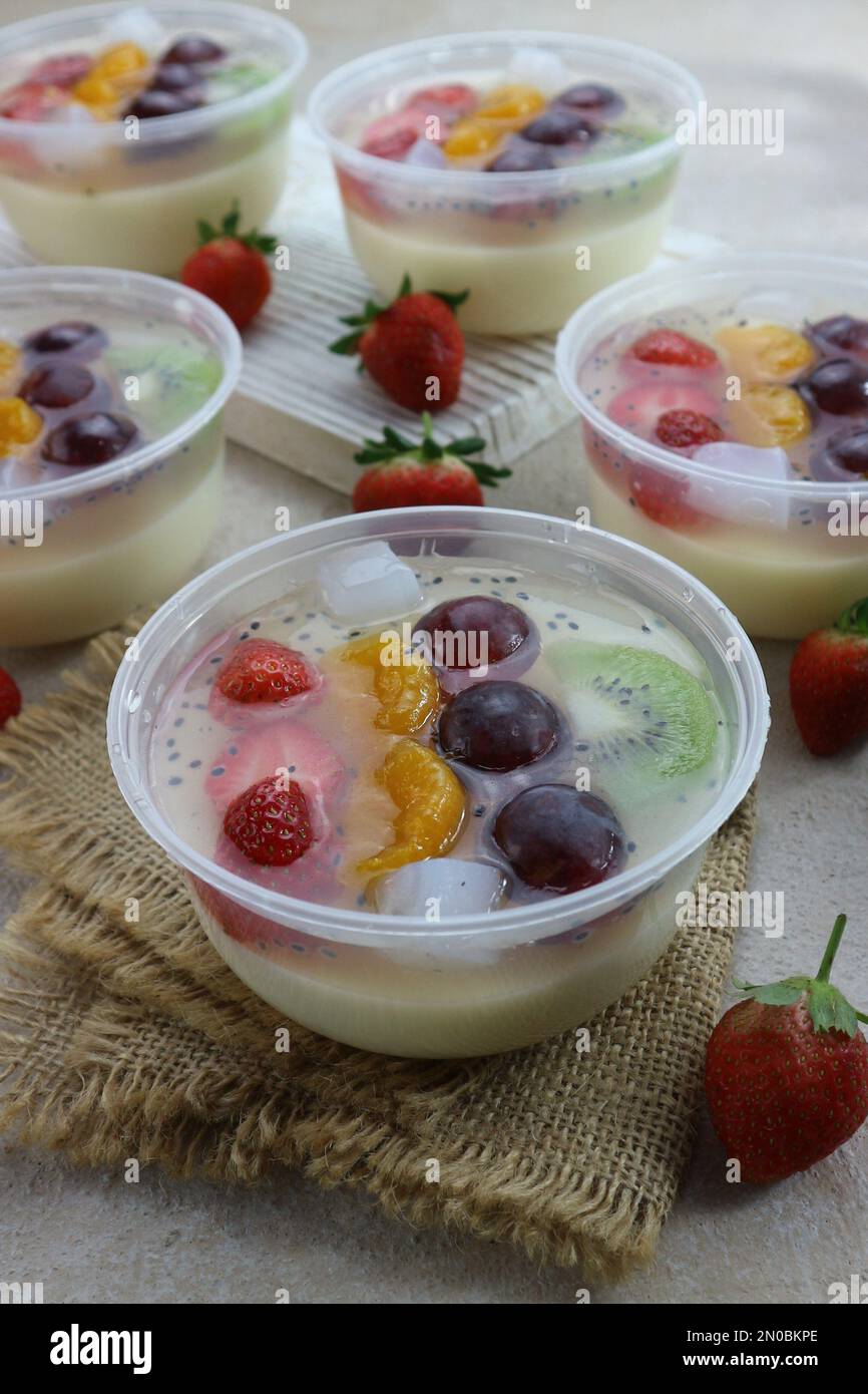 Pudding filled with grape slices, strawberry slices, orange slices ...