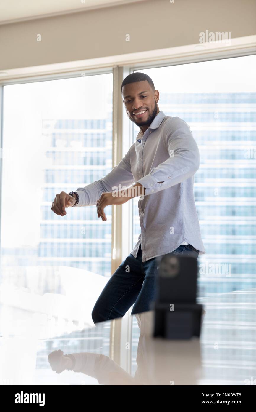 Happy handsome energetic influencer, blogger man dancing at camera ...