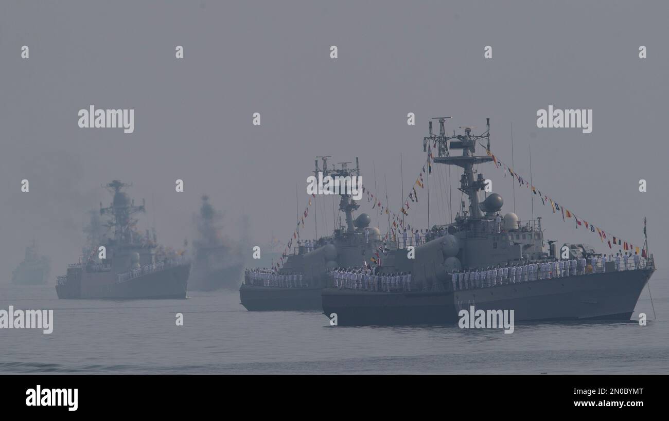 Indian sailors on a veer class corvette take their caps in their hand ...