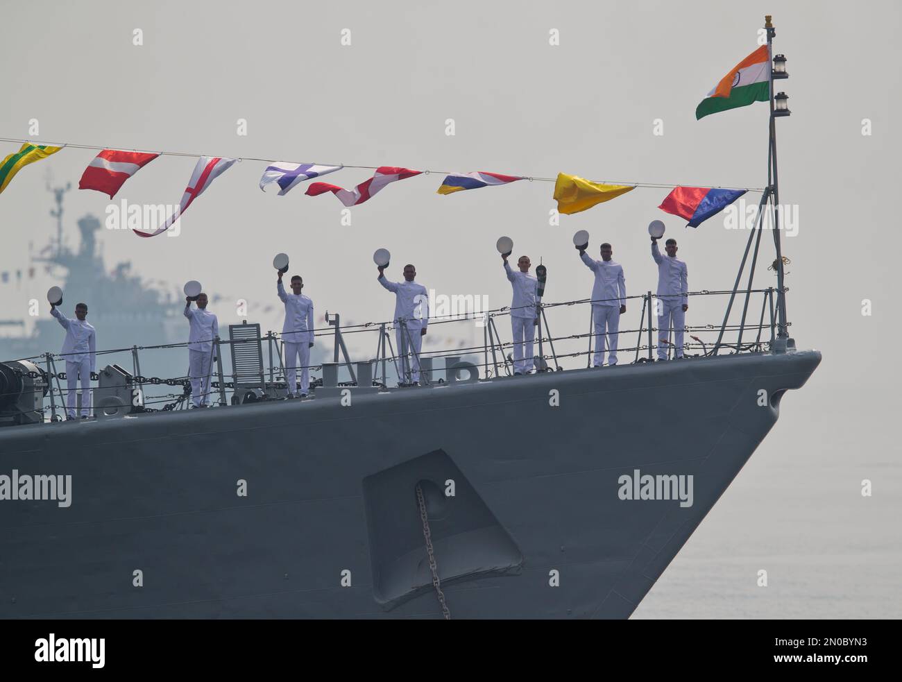 Indian sailors on a khukri class corvette take their caps in their hand ...