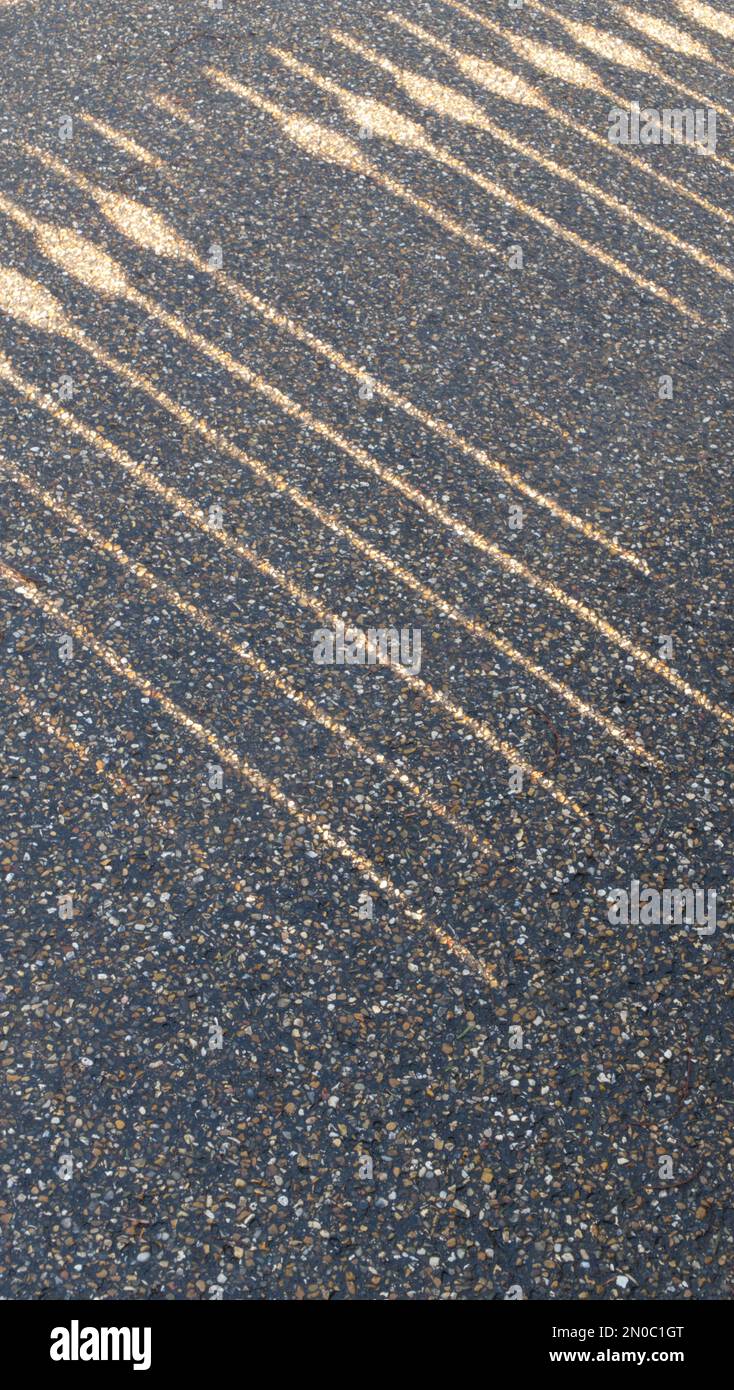 Pattern cast by shadows from decorative holes in a bench Stock Photo ...