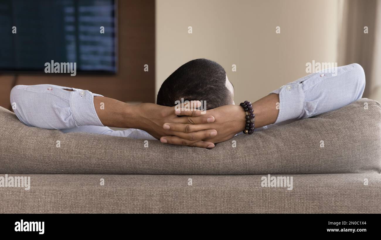 Head and hands of young Black man resting in sofa Stock Photo - Alamy
