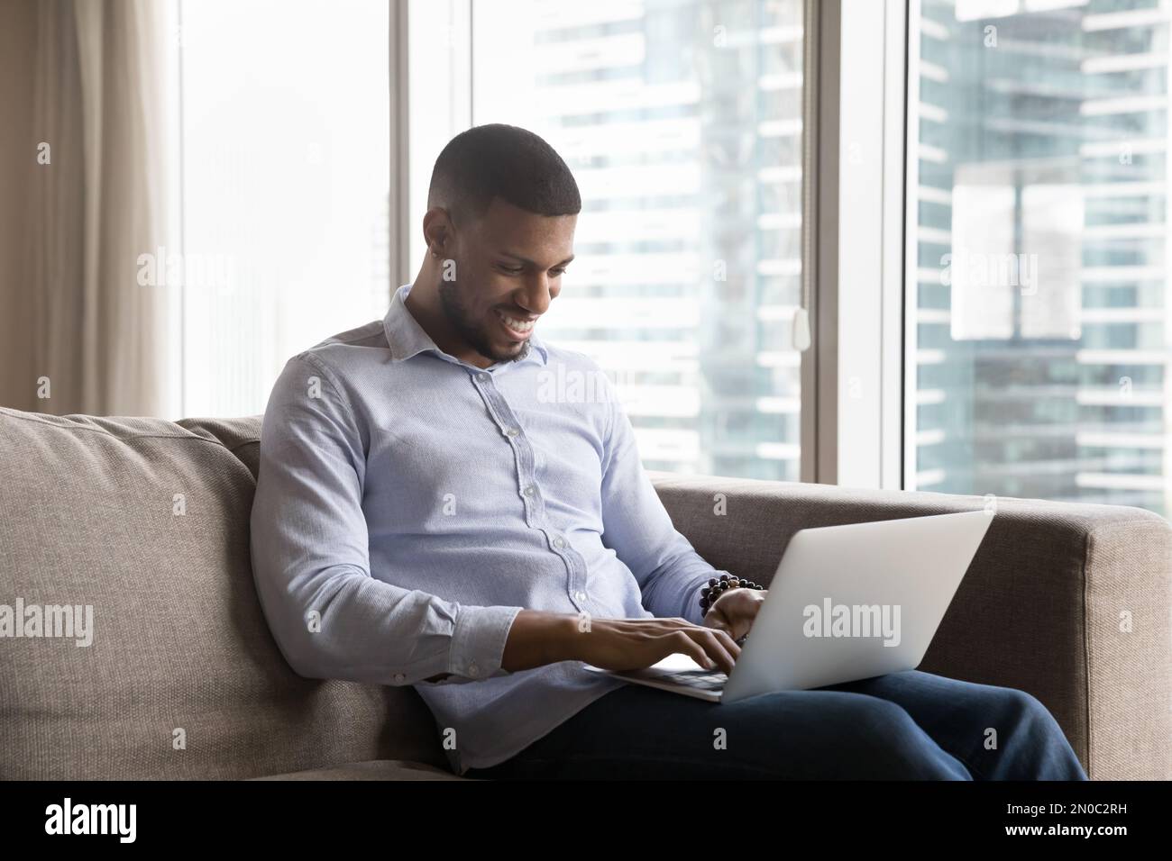 Young black man typing hi-res stock photography and images - Alamy