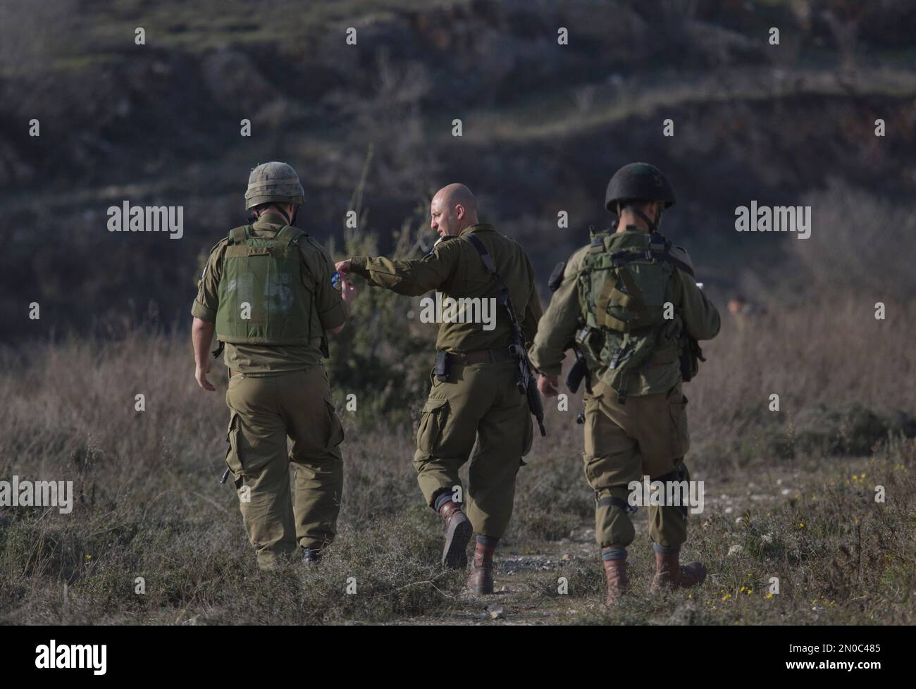 Israeli army officers inspect the site near the body of Haytham al-Baw ...