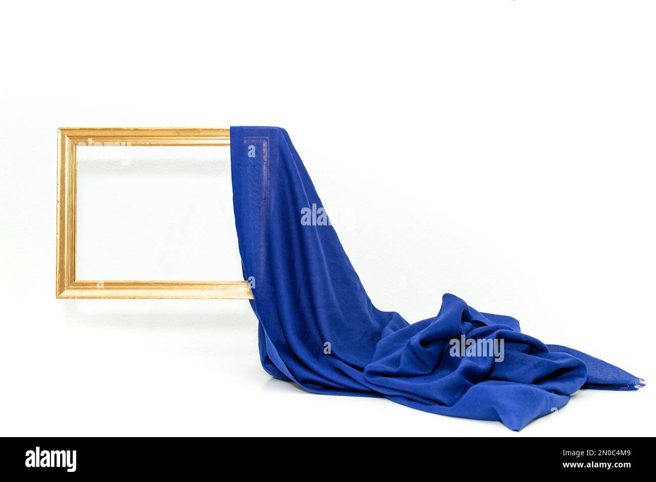 Blue fabric curtains unveiling a levitating golden empty frame, on ...