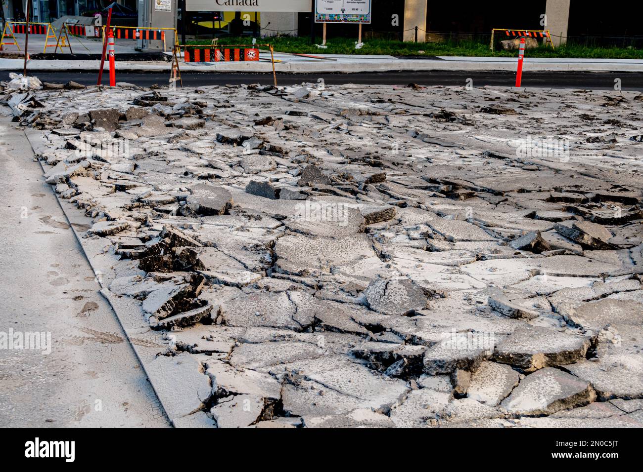 Asphalt road surface torn up to be replaced in city Stock Photo - Alamy
