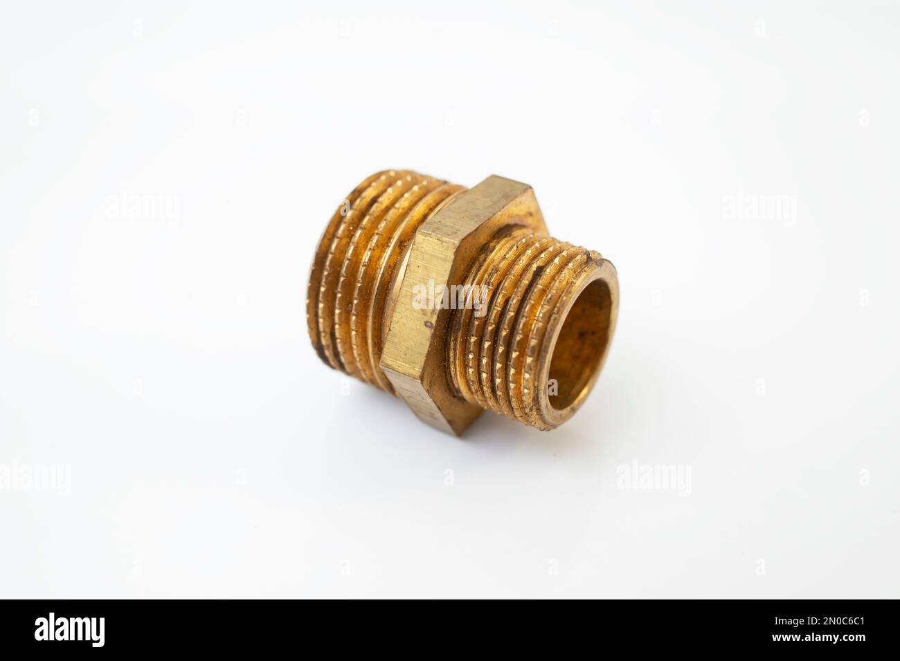 Golden screw reduction connector for water pipes, close up isolated on ...