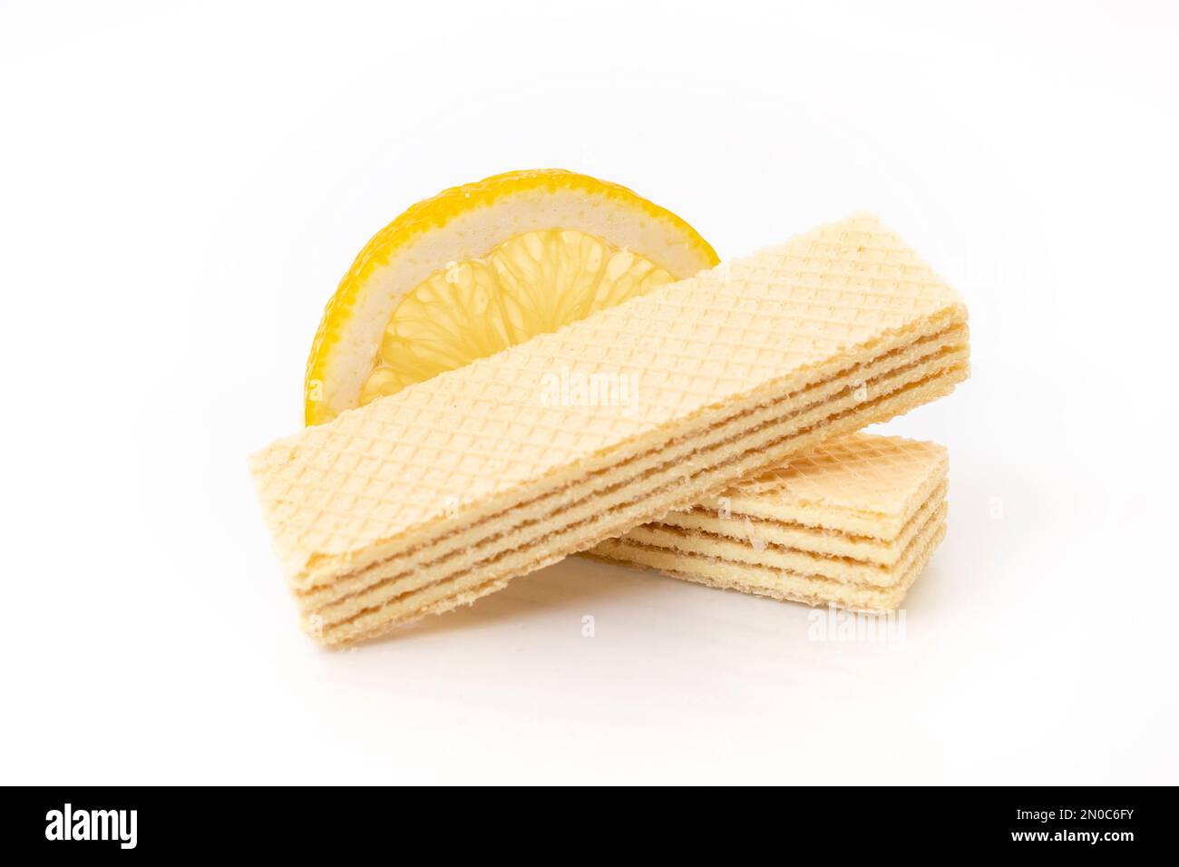 two wafers and a slice of lemon on white background Stock Photo - Alamy
