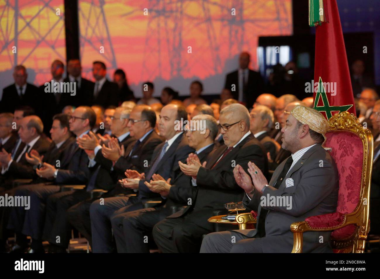 King Mohammed VI of Morocco, right, applauds a speech before inaugurating the solar plant of ...